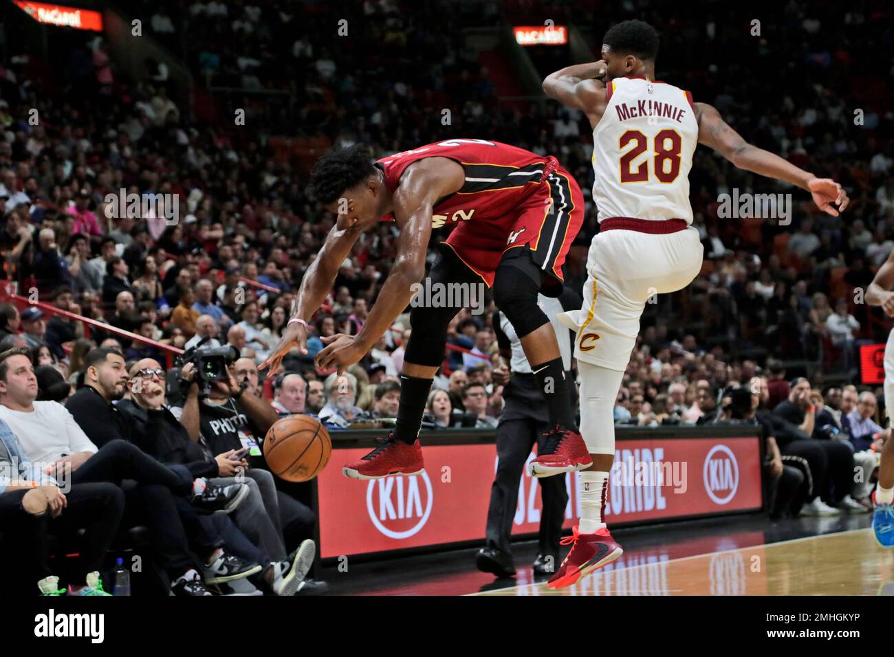 Miami Heat forward Jimmy Butler, left, collides with Cleveland ...
