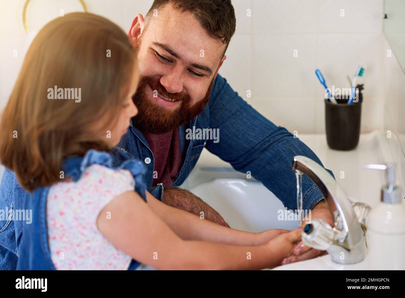 Say bye by to the bacteria. an adorable little girl washing her hands ...