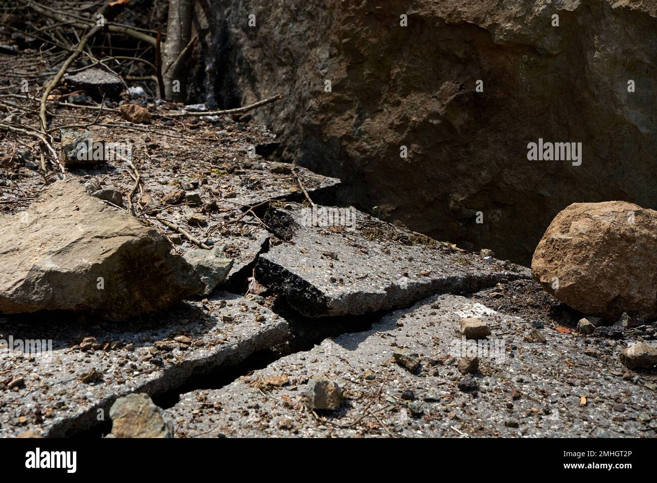 A huge rock fell from the mountains onto the road, destroying the ...