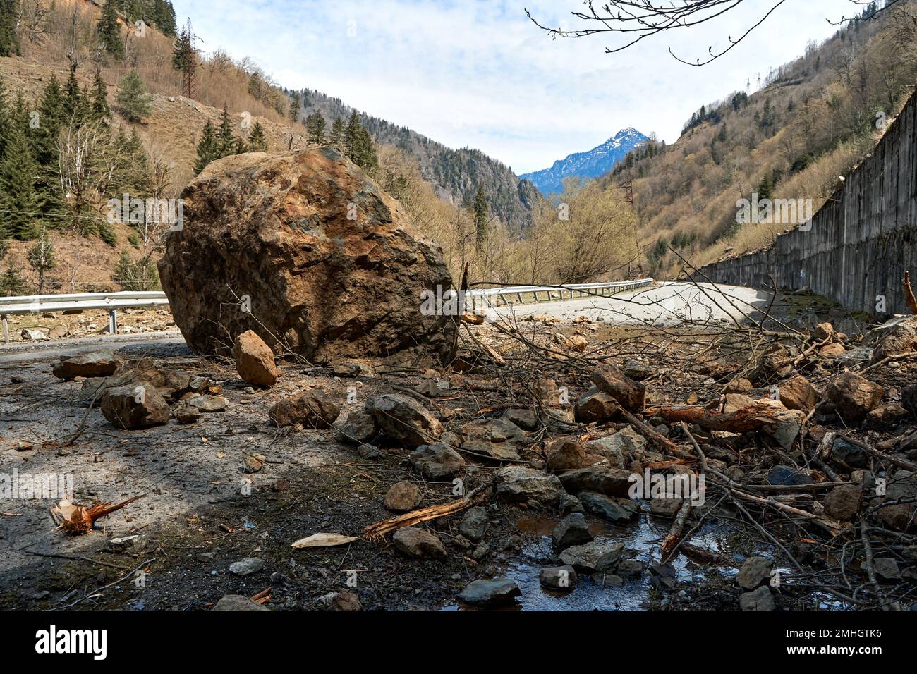 A huge rock fell from the mountains onto the road, destroying the ...