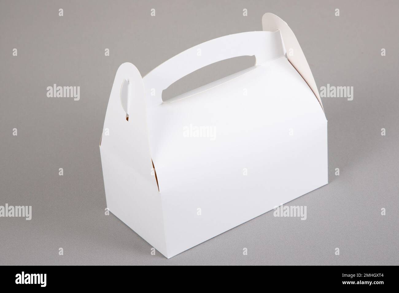 White blank paper pastries candies box with handle in grey background ...