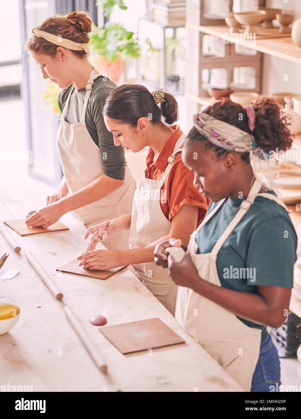 Pottery art and creative people row in workshop sculpting together for ...