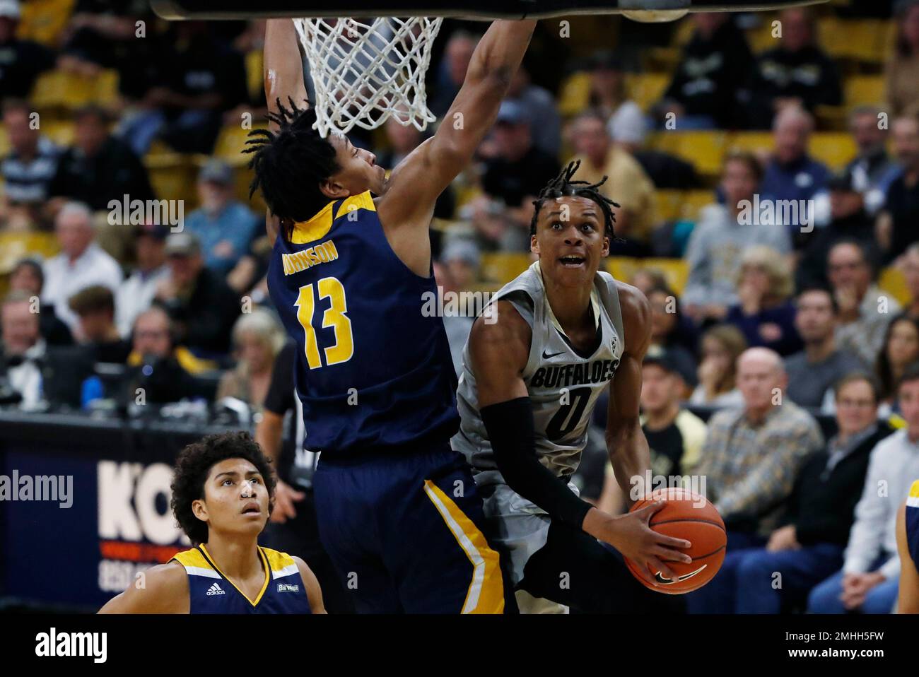 Colorado guard Shane Gatling, right, goes up for a basket as UC Irvine ...