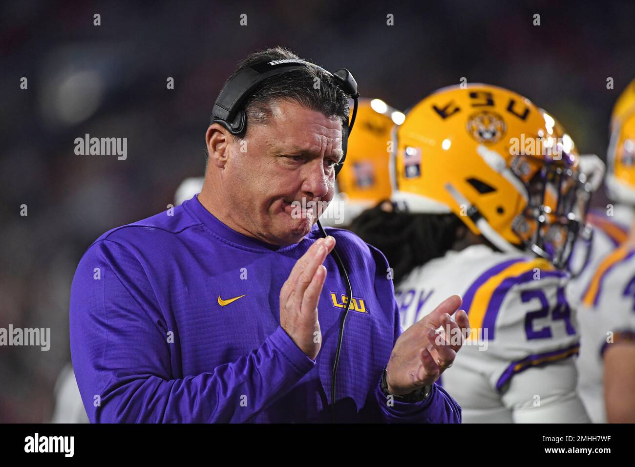 LSU head coach Ed Orgeron claps during a timeout during the first half of an NCAA college ...