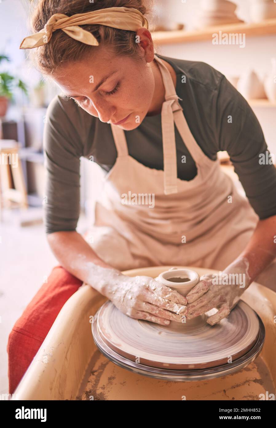 Woman, sculpture artist and mud wheel for clay design, creative ...