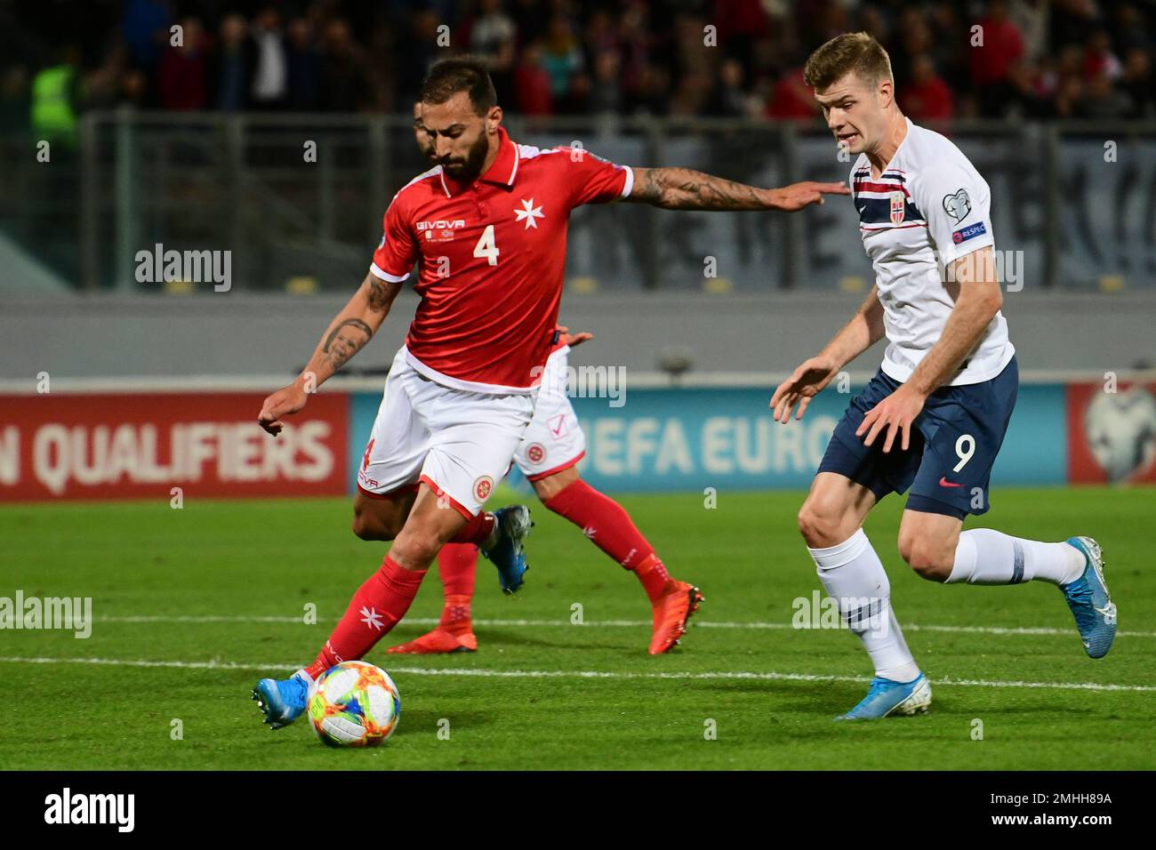 Malta's Steve Borg, left, and Norway's Alexander Sorloth fight for the ...