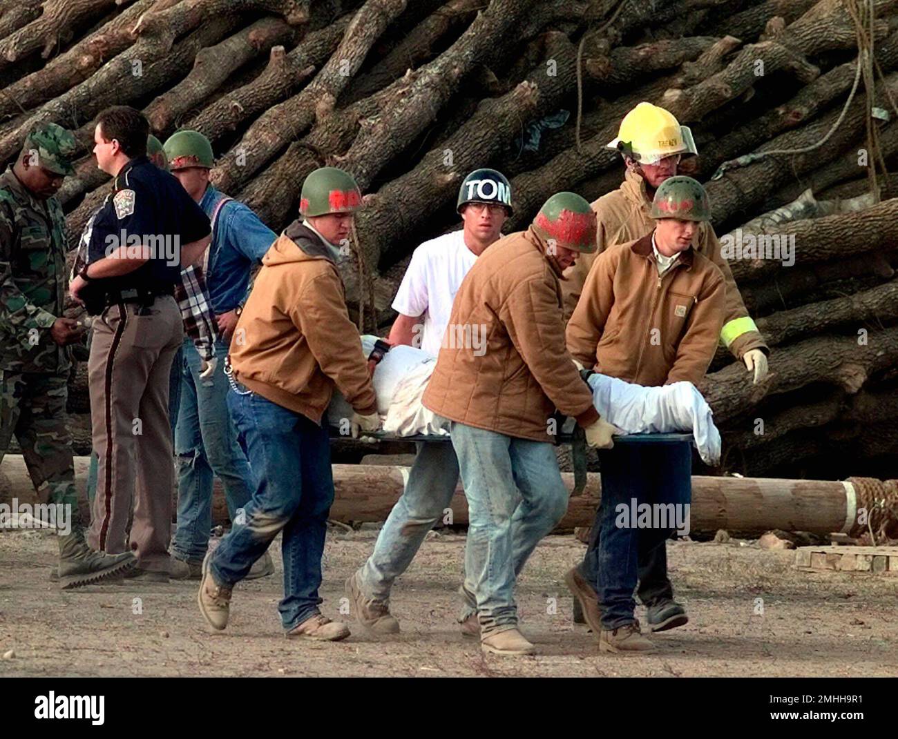 FILE - In this Nov. 18, 1999 file photo, a body is carried from the ...