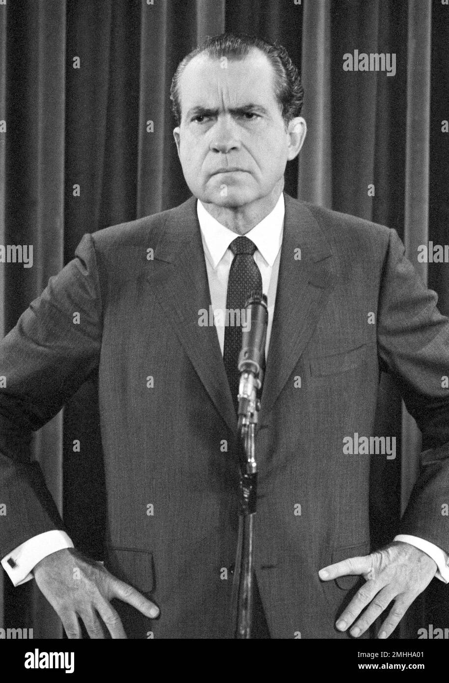 President Richard Nixon stands with his hands on his hips during a ...