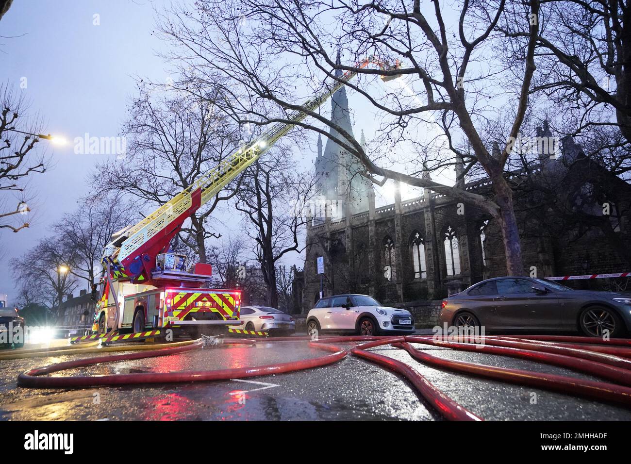 Firefighters use hoses to dampen down at the scene of a fire at St Mark ...