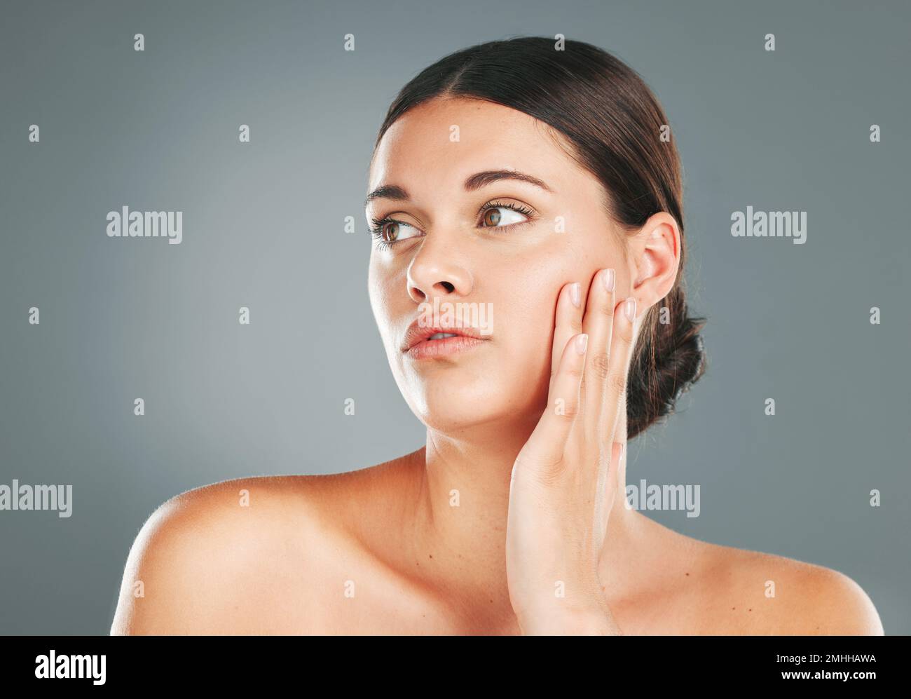 Beauty, skincare and woman touching face in studio for wellness, clean ...