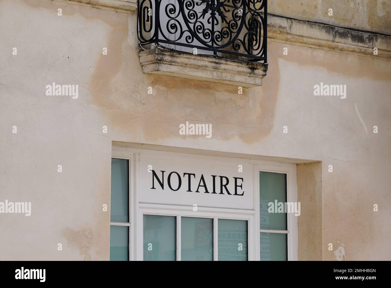 Notaire french text sign means notary in wall windows building entrance ...
