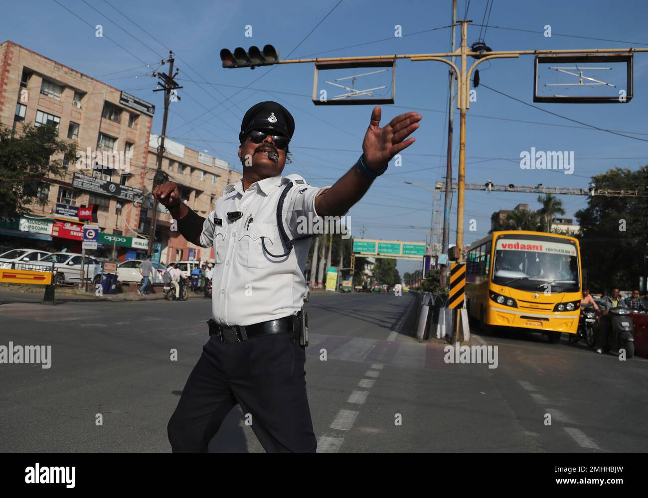 Ranjeet Singh, an Indian traffic policeman directs commuters at a busy ...