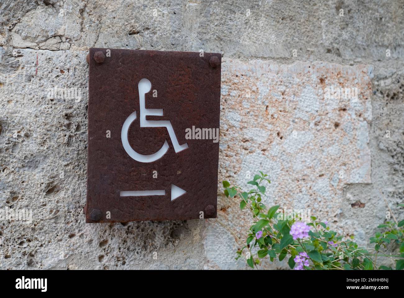 disabled accessible arrow entry sign post with wheelchair handicap logo ...