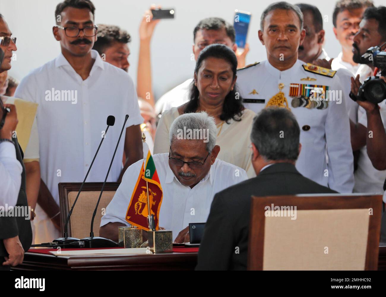 Sri Lanka's newly elected president Gotabaya Rajapaksa, center signs ...