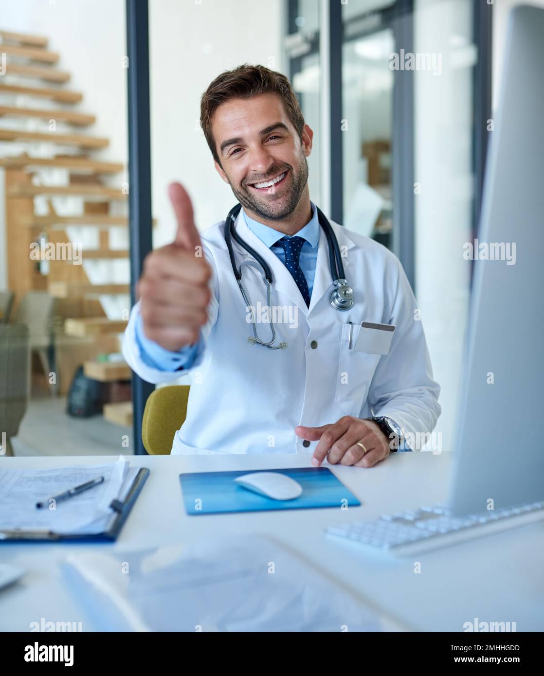 Im glad to see youre looking better. Portrait of a young doctor showing ...