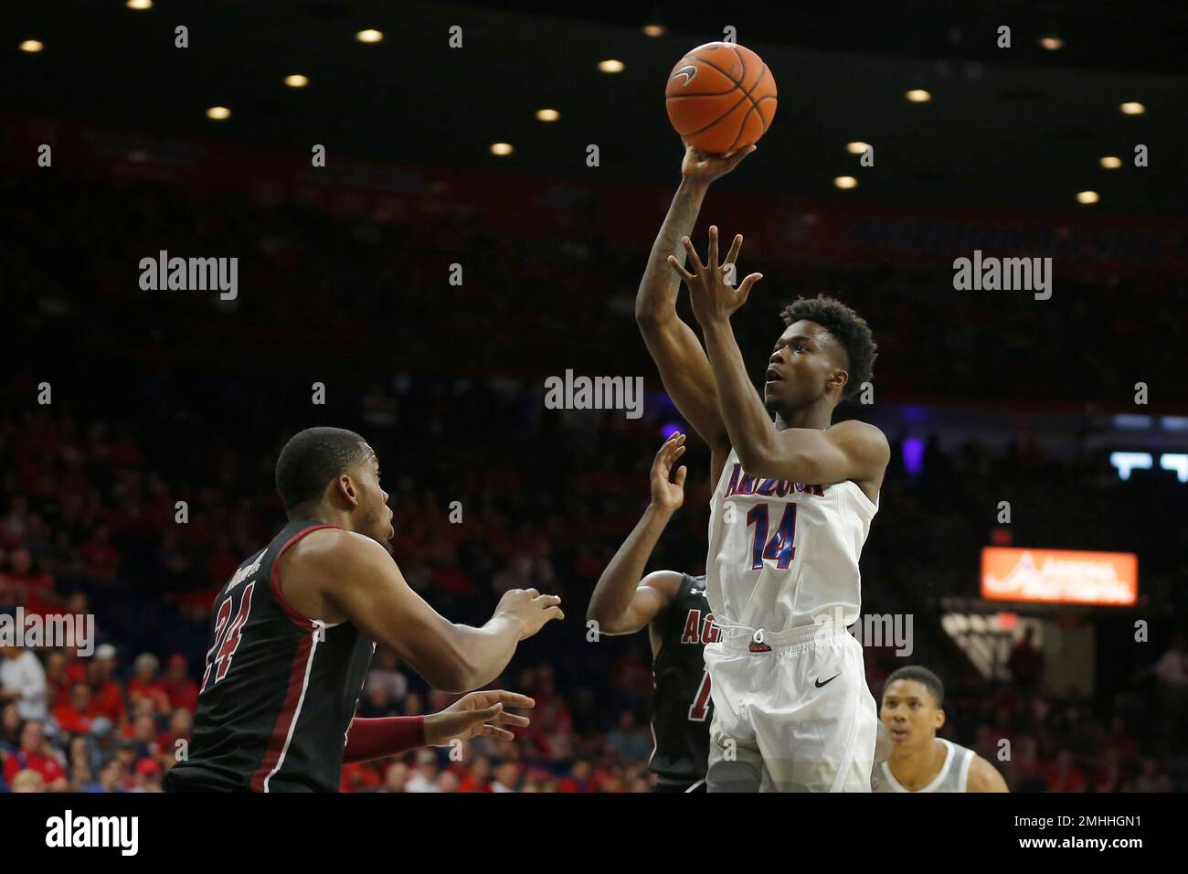 Arizona guard Devonaire Doutrive (14) shoots over New Mexico State ...