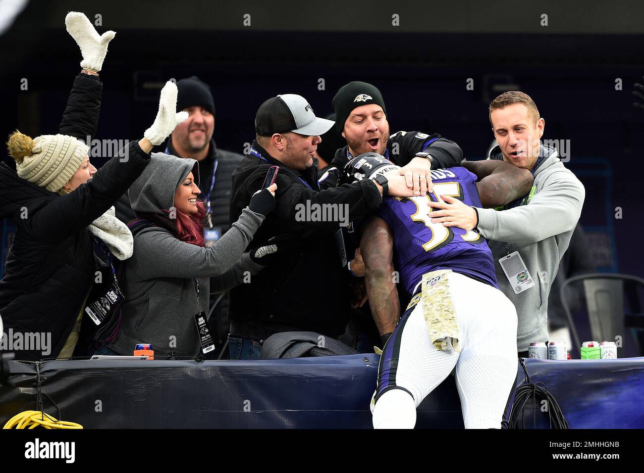 Baltimore Ravens running back Gus Edwards jumps onto fans after running ...