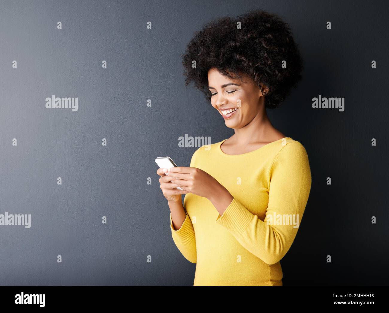 Female sending text message via mobile phone Stock Photo - Alamy