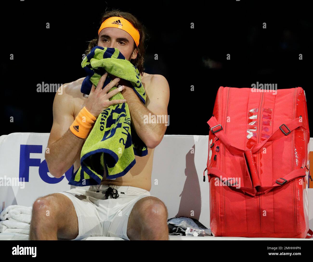 Stefanos Tsitsipas of Greece changes his shirt during a change over as ...