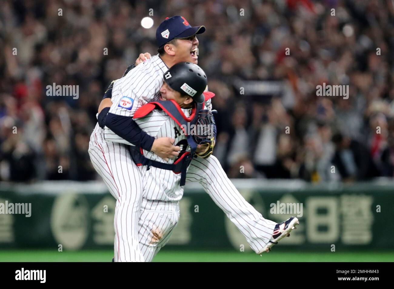 Japan's pitcher Yasuaki Yamasaki celebrates with catcher Tsubasa Aizawa ...