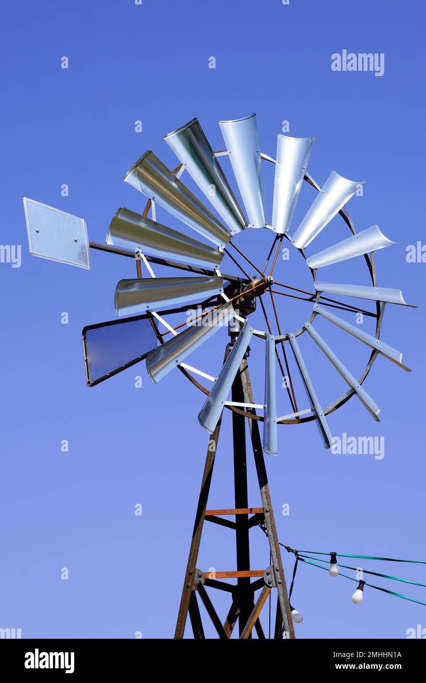 vintage wind turbine small windmill by blue sky Stock Photo - Alamy