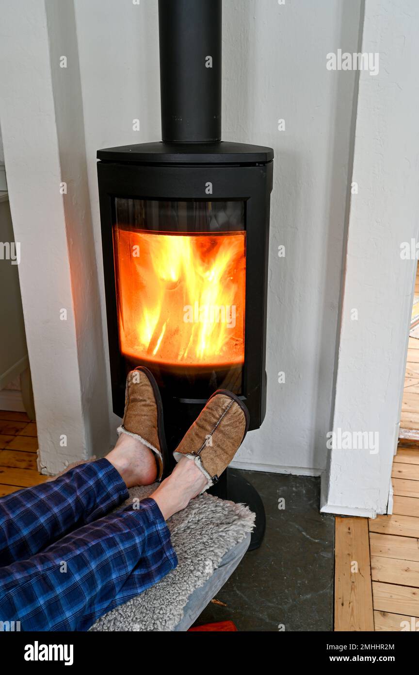 man in pyjamas sitting infront ov cast iron stone Stock Photo - Alamy