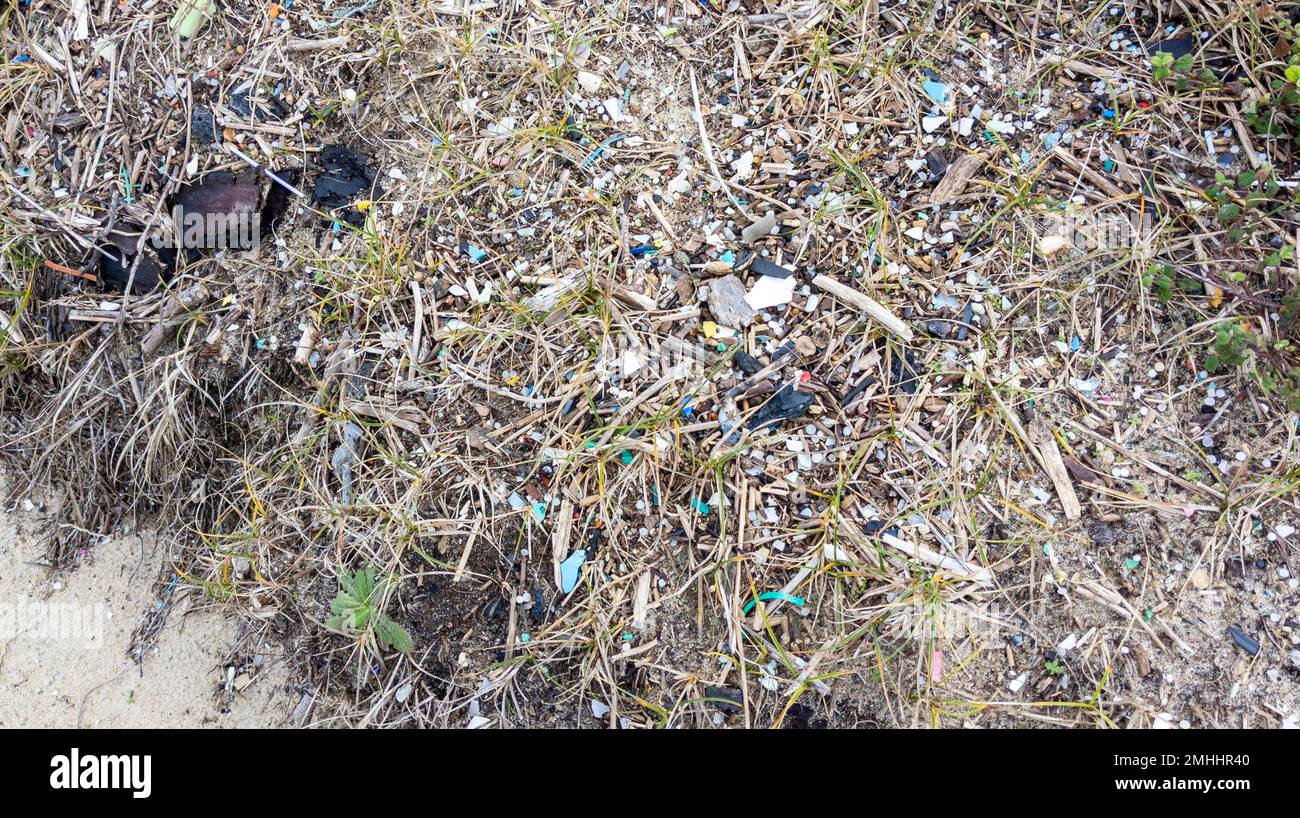 Beach plastic pollution Microplastics on a beach in pollution concept ...