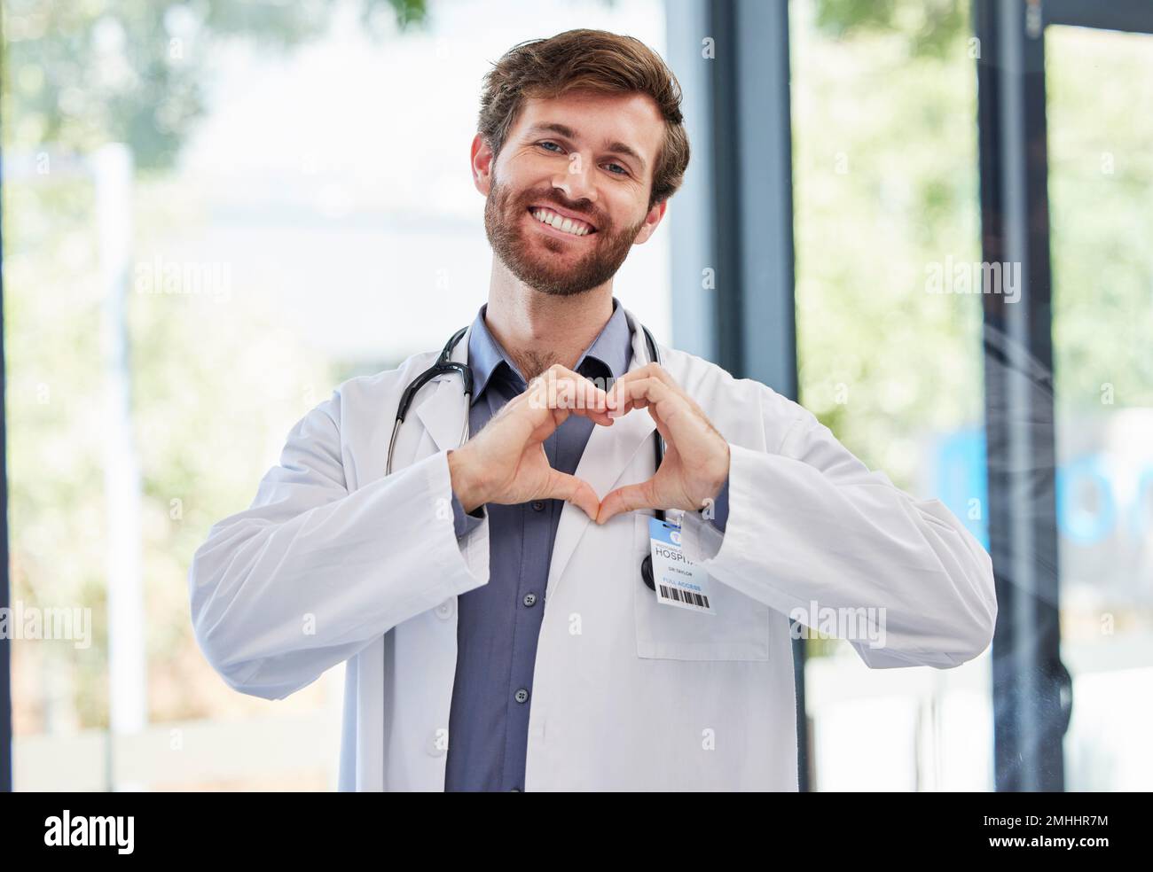 Doctor, man and heart hands with smile at hospital for support ...