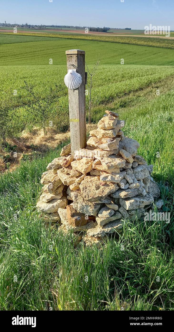 pathway roadsign scallop shell hanging on the pole on a pile of stone ...