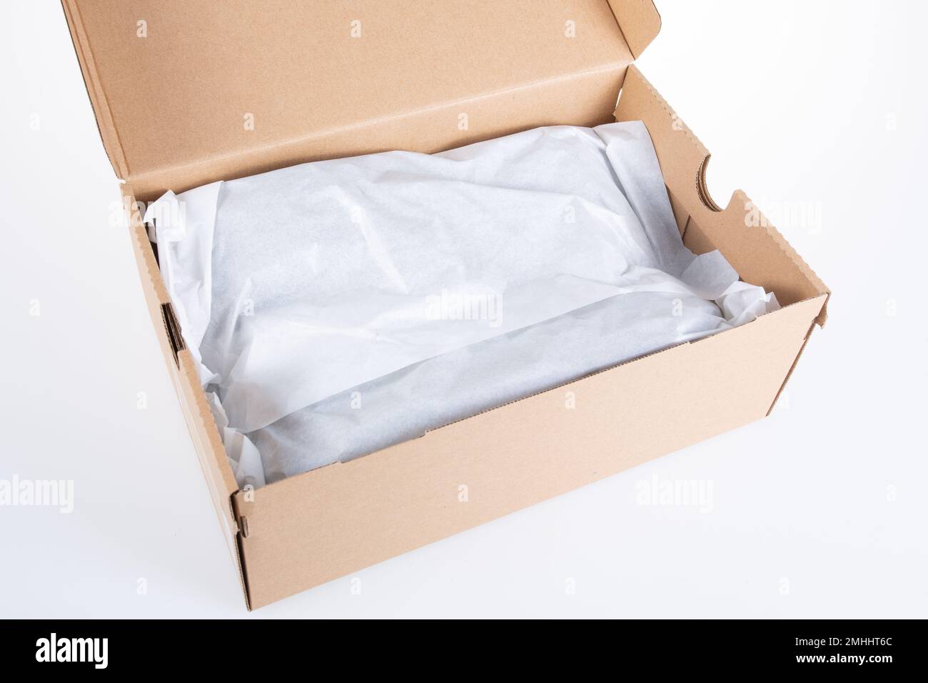 Open empty shoe cardboard box with paper protect Stock Photo - Alamy