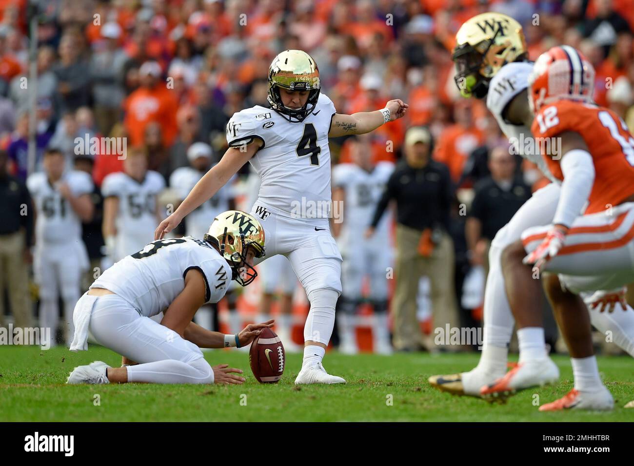 Wake Forest's Nick Sciba (4), with Dom Maggio holding, boots a field ...