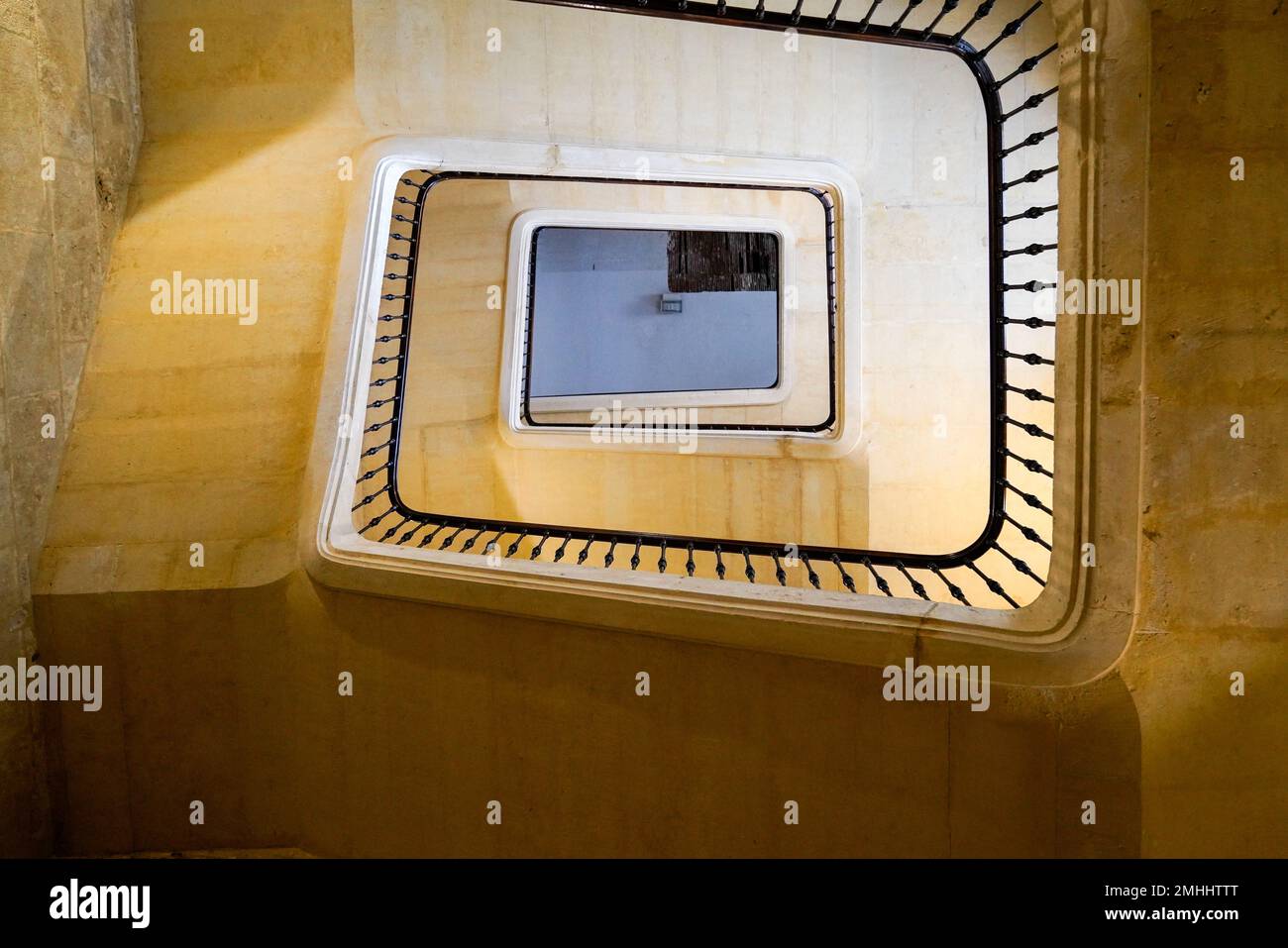 Beautiful rectangular staircase in an old house in view from the bottom ...