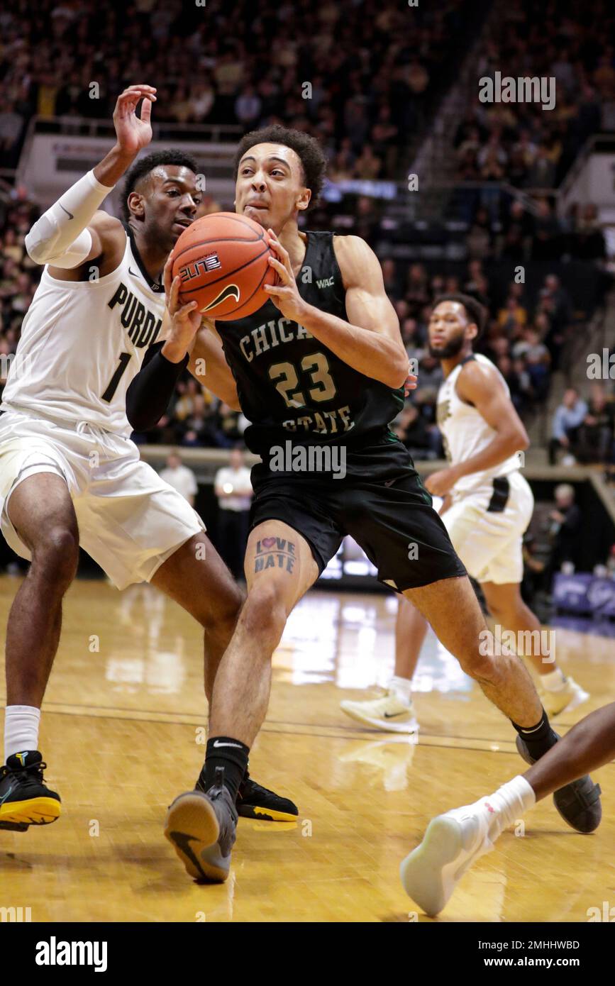 Chicago State forward Jace Colley (23) drives around Purdue forward ...