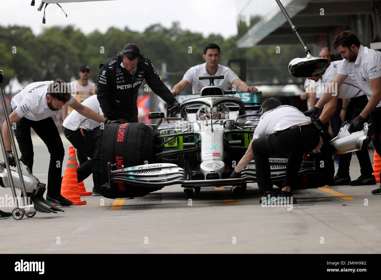 Pit crew works on the car of Mercedes driver Lewis Hamilton, of Britain ...