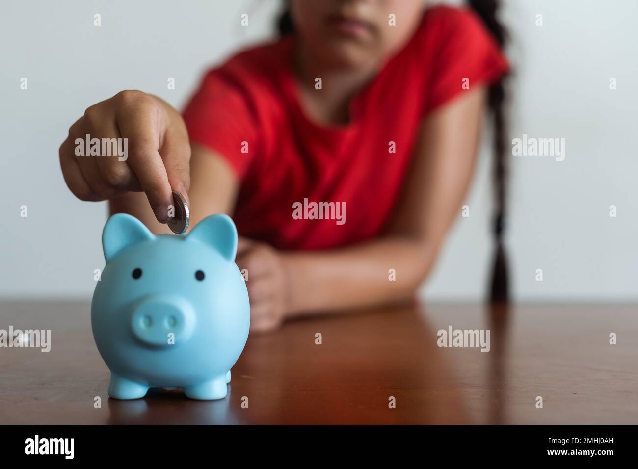 Little child girl with piggy bank at home Stock Photo - Alamy