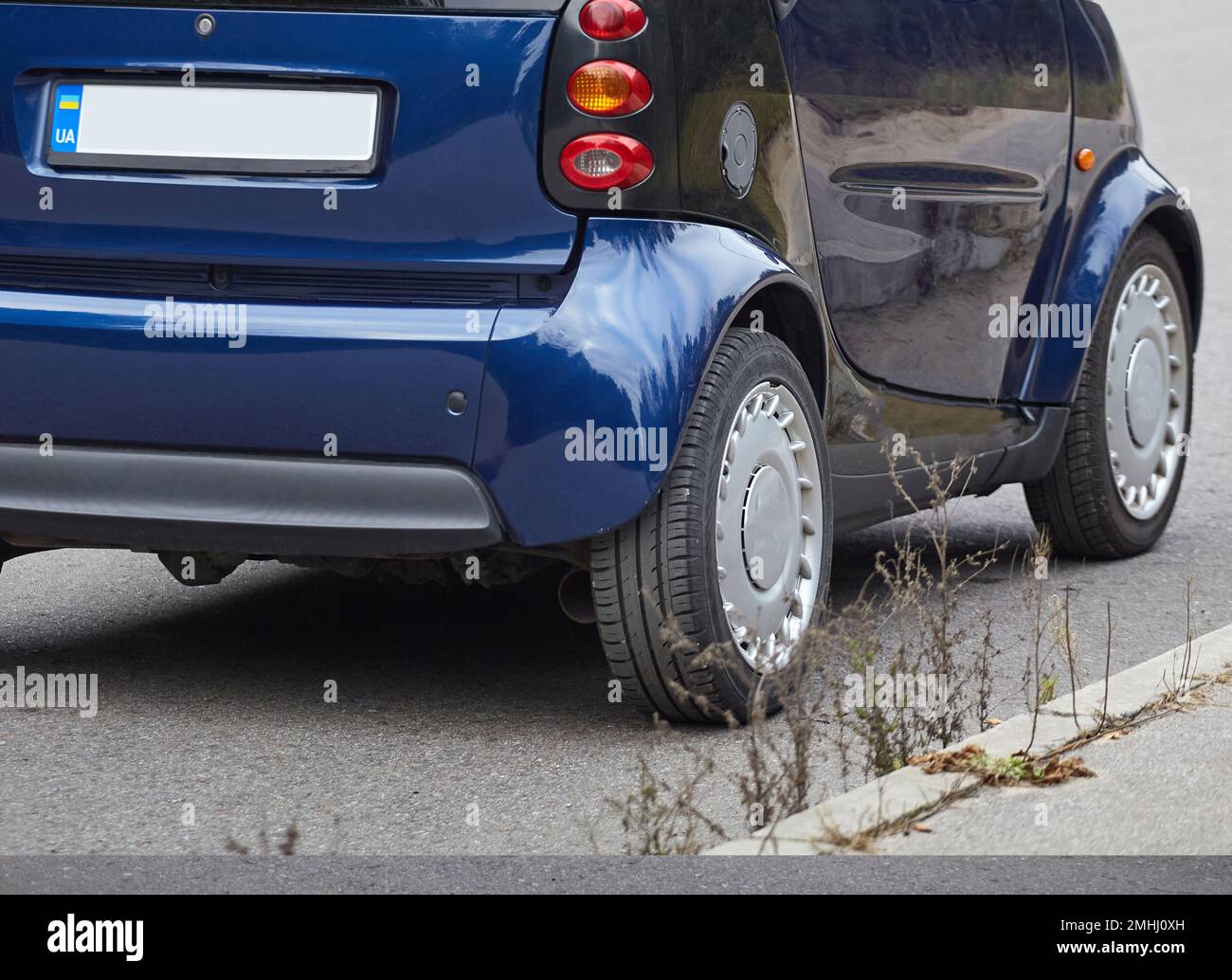 Little blue car driving on the road, modern city car background Stock ...