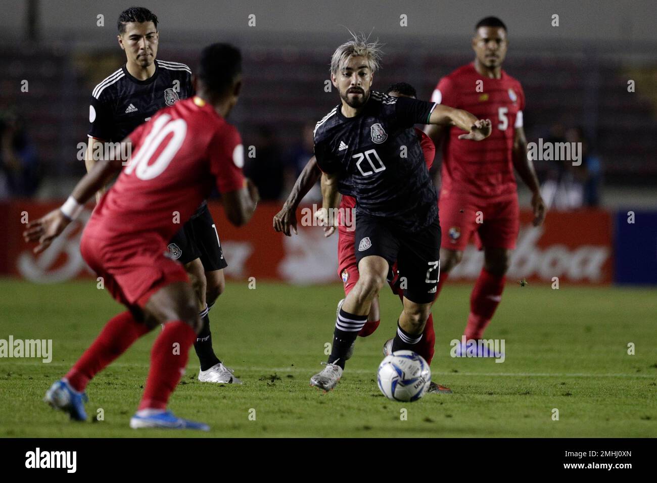 Mexico's Rodolfo Pizarro, center, dribbles the ball during a CONCACAF ...