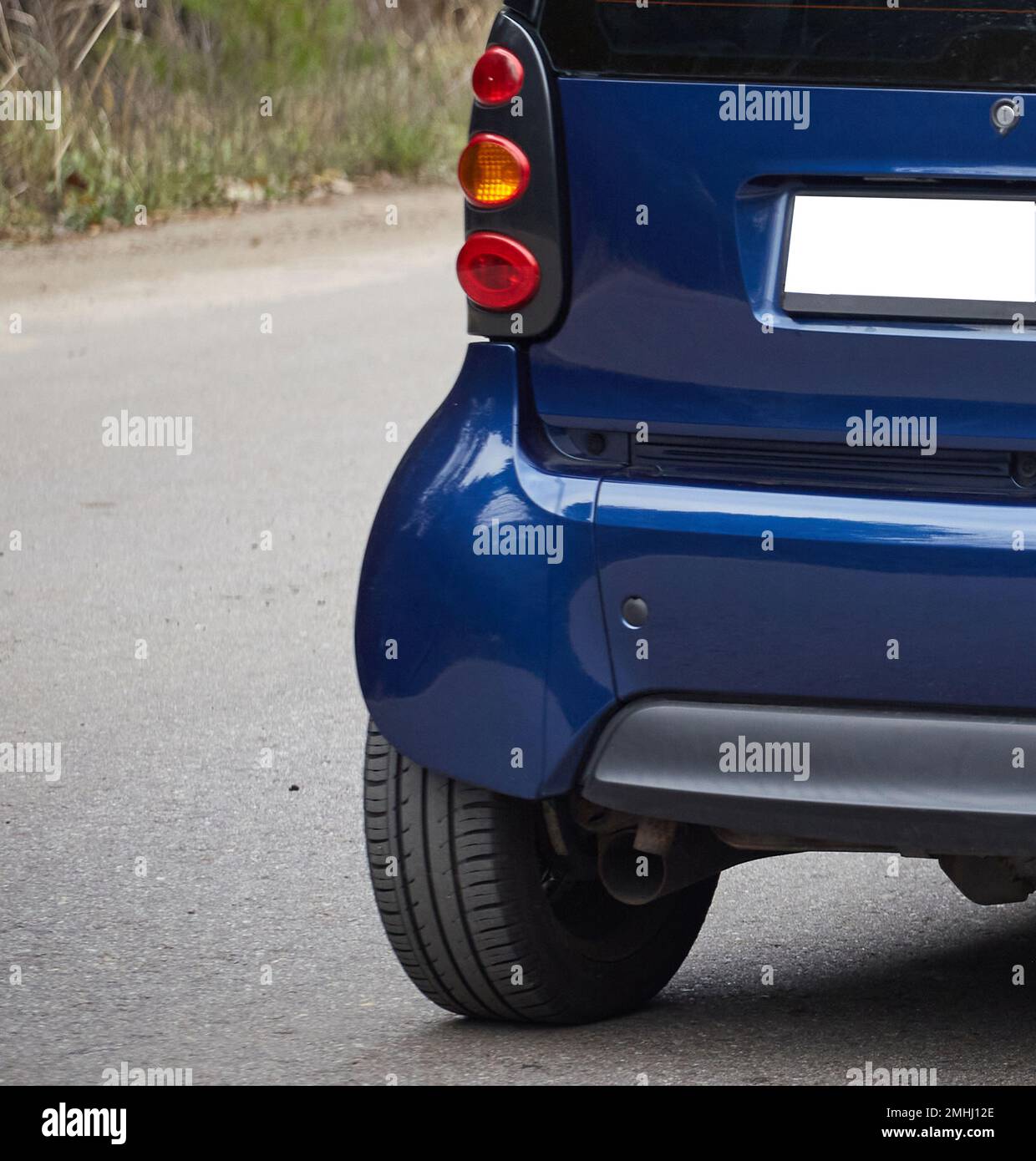 Little blue car driving on the road, modern city car background Stock ...
