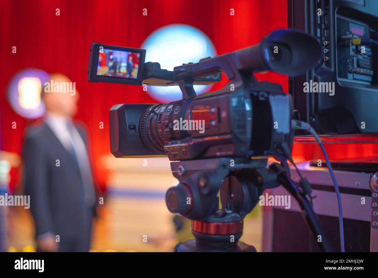 cameraman filming an interview on a tv camera Stock Photo - Alamy