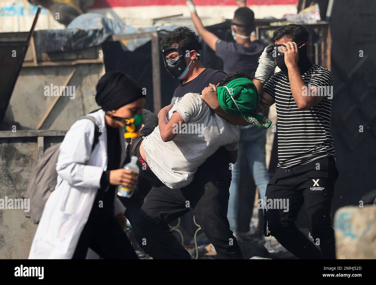 An injured protester is rushed to a hospital during clashes between ...