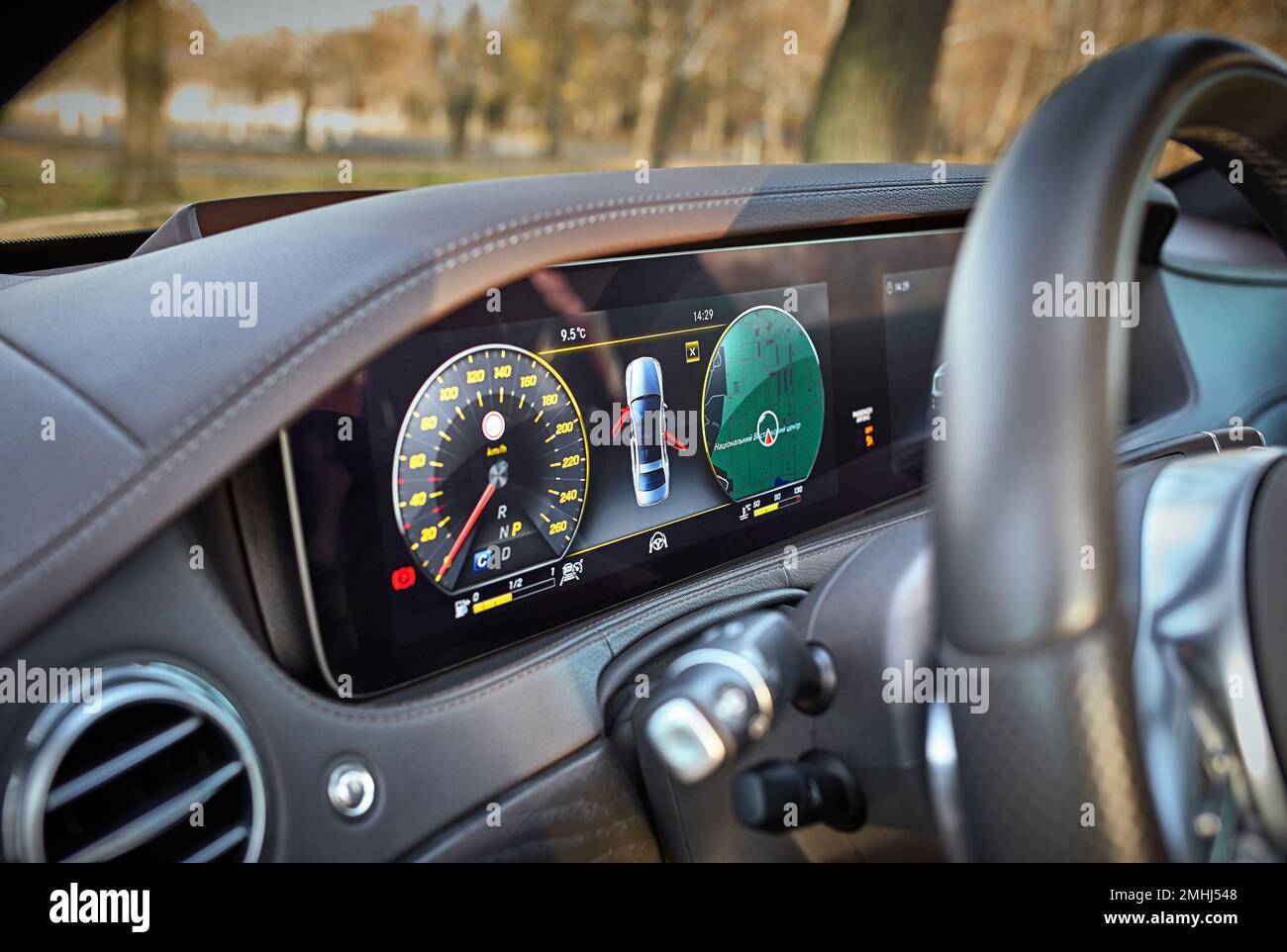 Car steering wheel with car dashboard computer and interior background ...