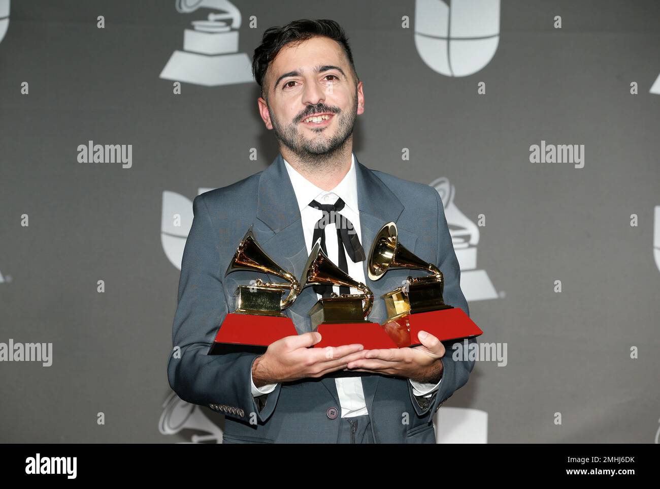 El Guincho poses in the press room with the awards for album of the ...