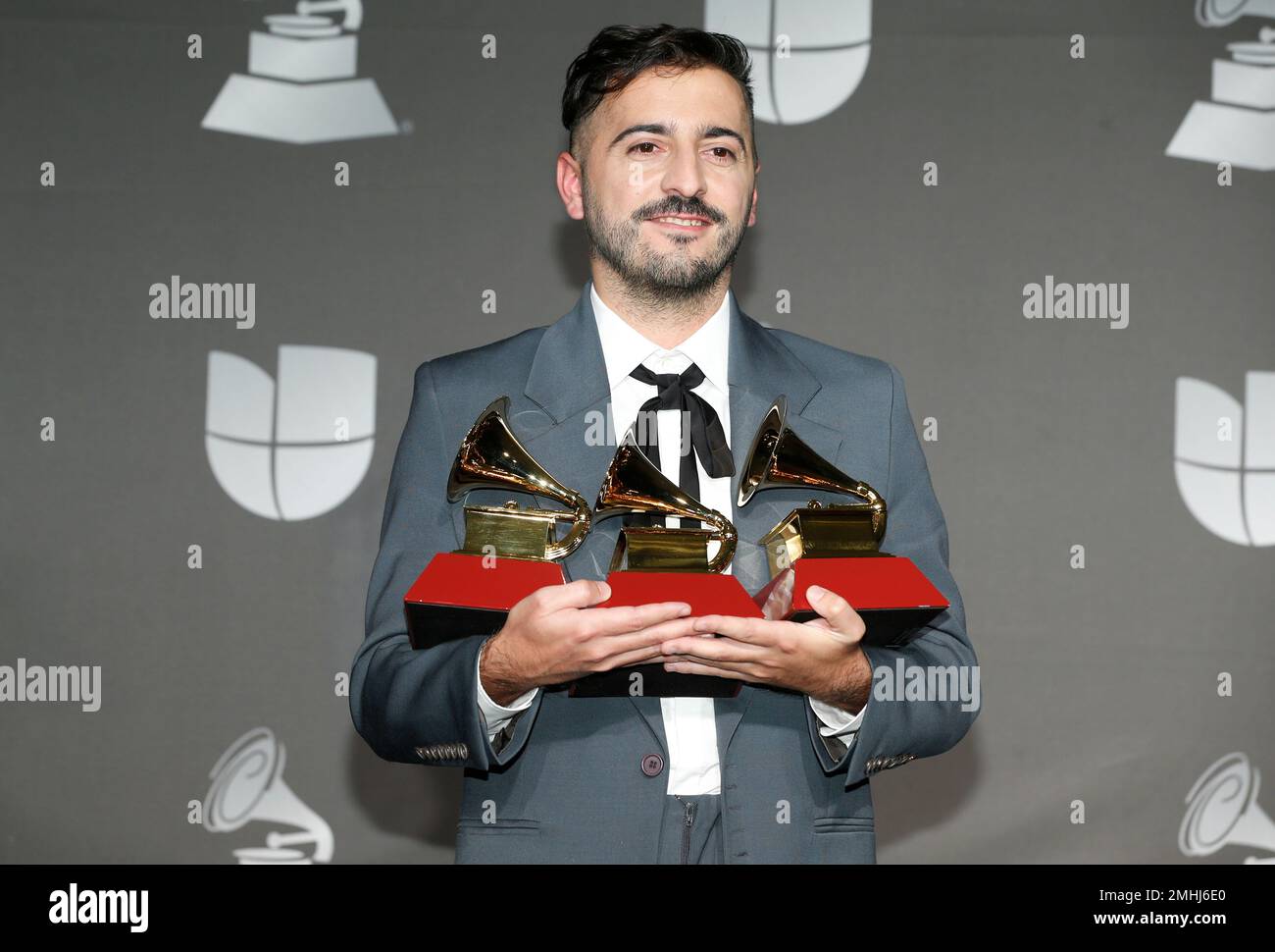 El Guincho poses in the press room with the awards for album of the ...