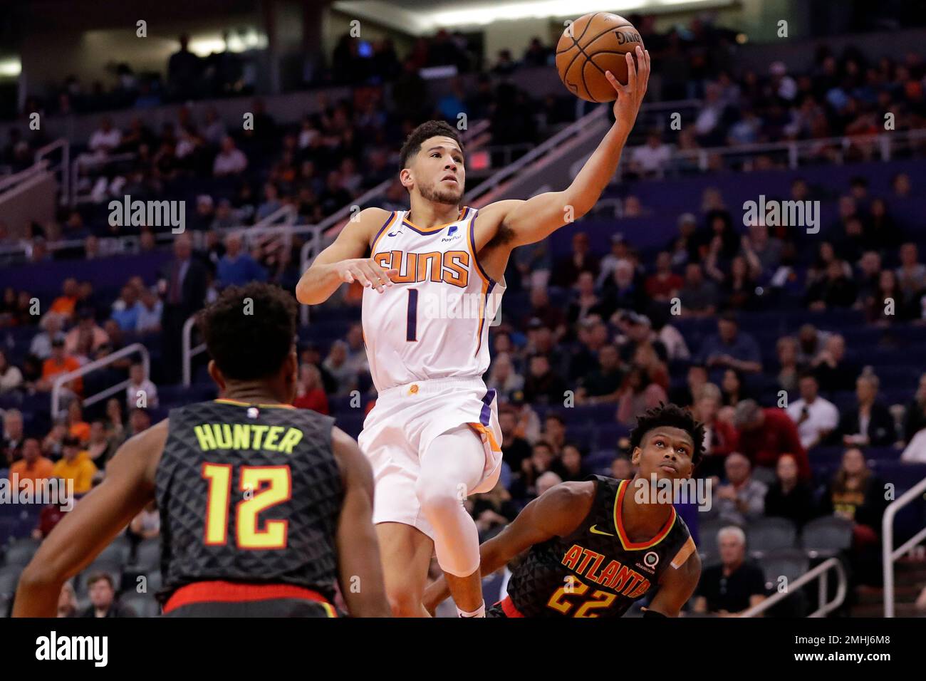 Phoenix Suns guard Devin Booker (1) shoots over Atlanta Hawks forward ...