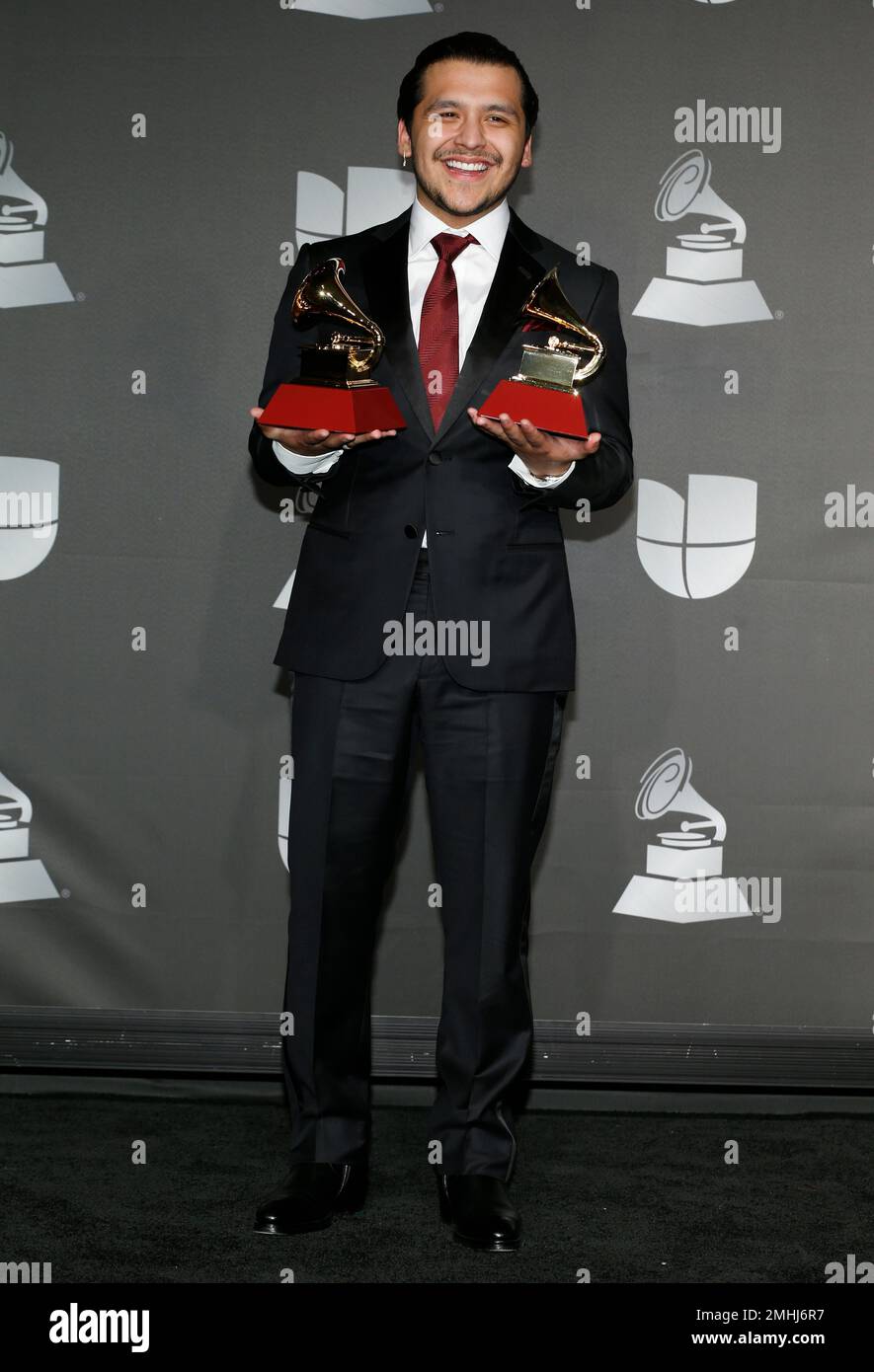 Christian Nodal poses in the press room with the awards for best ...