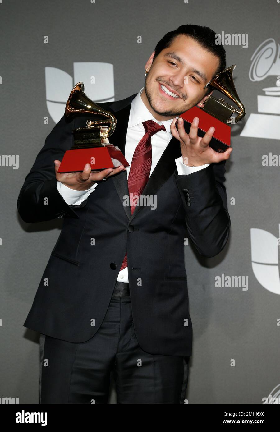 Christian Nodal poses in the press room with the awards for best ...