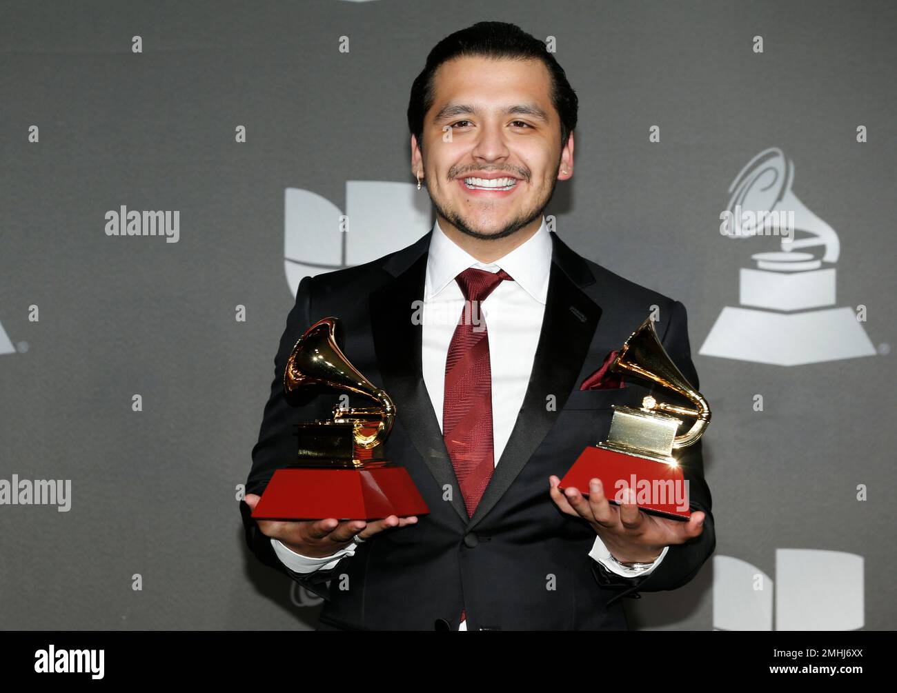 Christian Nodal poses in the press room with the awards for best ...