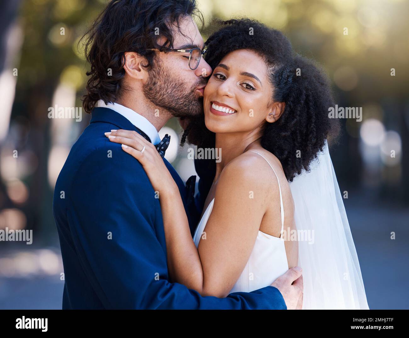 Wedding bride and groom kiss portrait at romantic outdoor marriage ...
