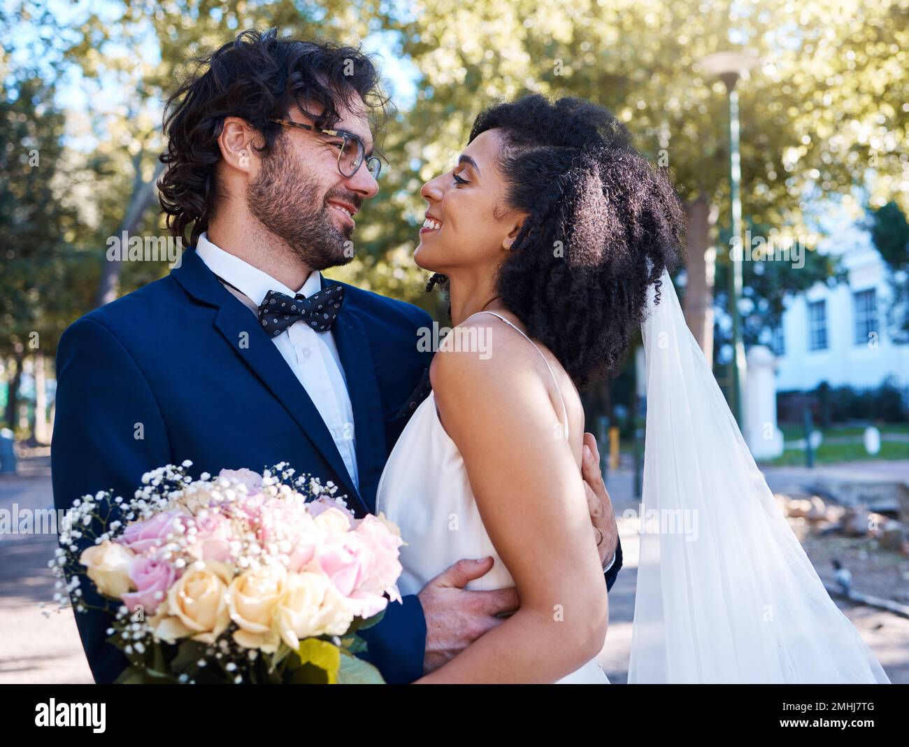 Interracial love and couple wedding with flowers for romantic outdoor ...