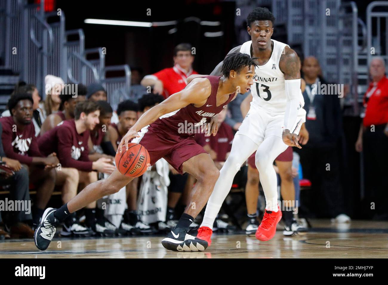 Alabama A&M's TJ Parham (0) drives past Cincinnati's Tre Scott (13 ...